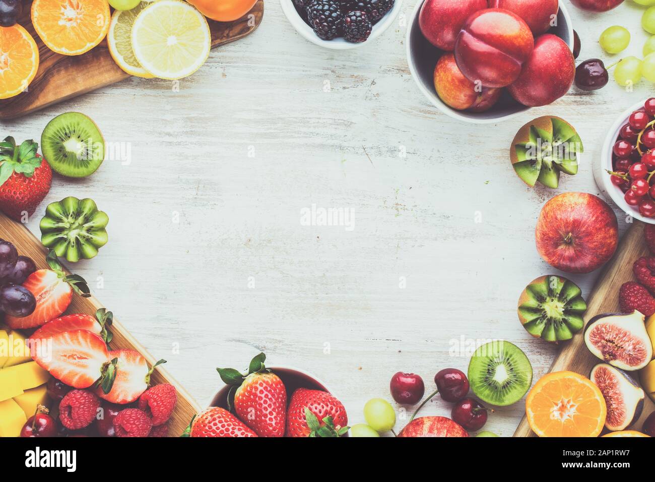 Healthy raw breakfast background, cut fruits, strawberries raspberries ...