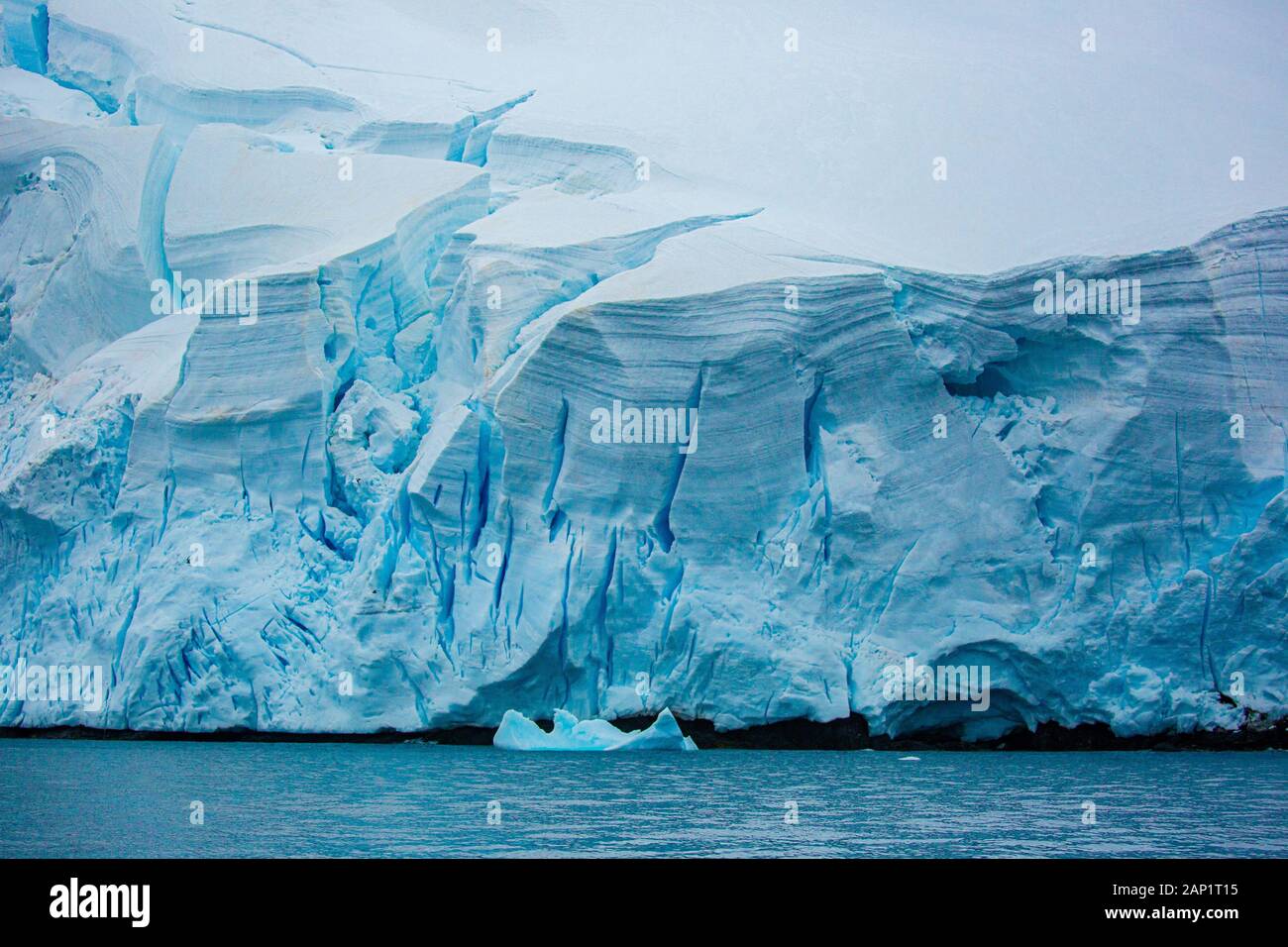 Blue ice of a glacier in Antarctica. The ice of blue icebergs contains ...