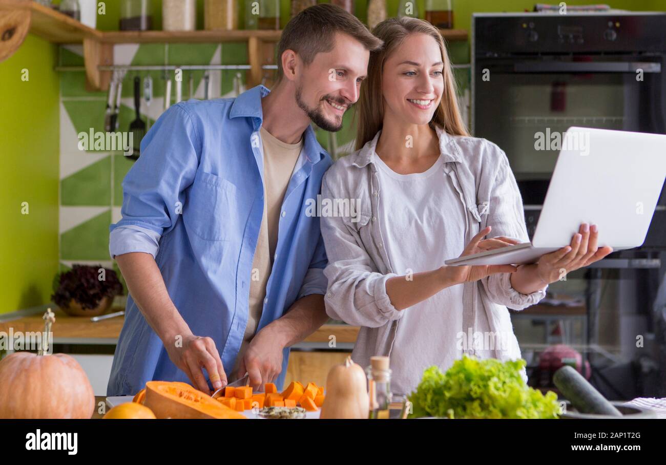 Young happy pair enjoying and preparing healthy meal Stock Photo - Alamy