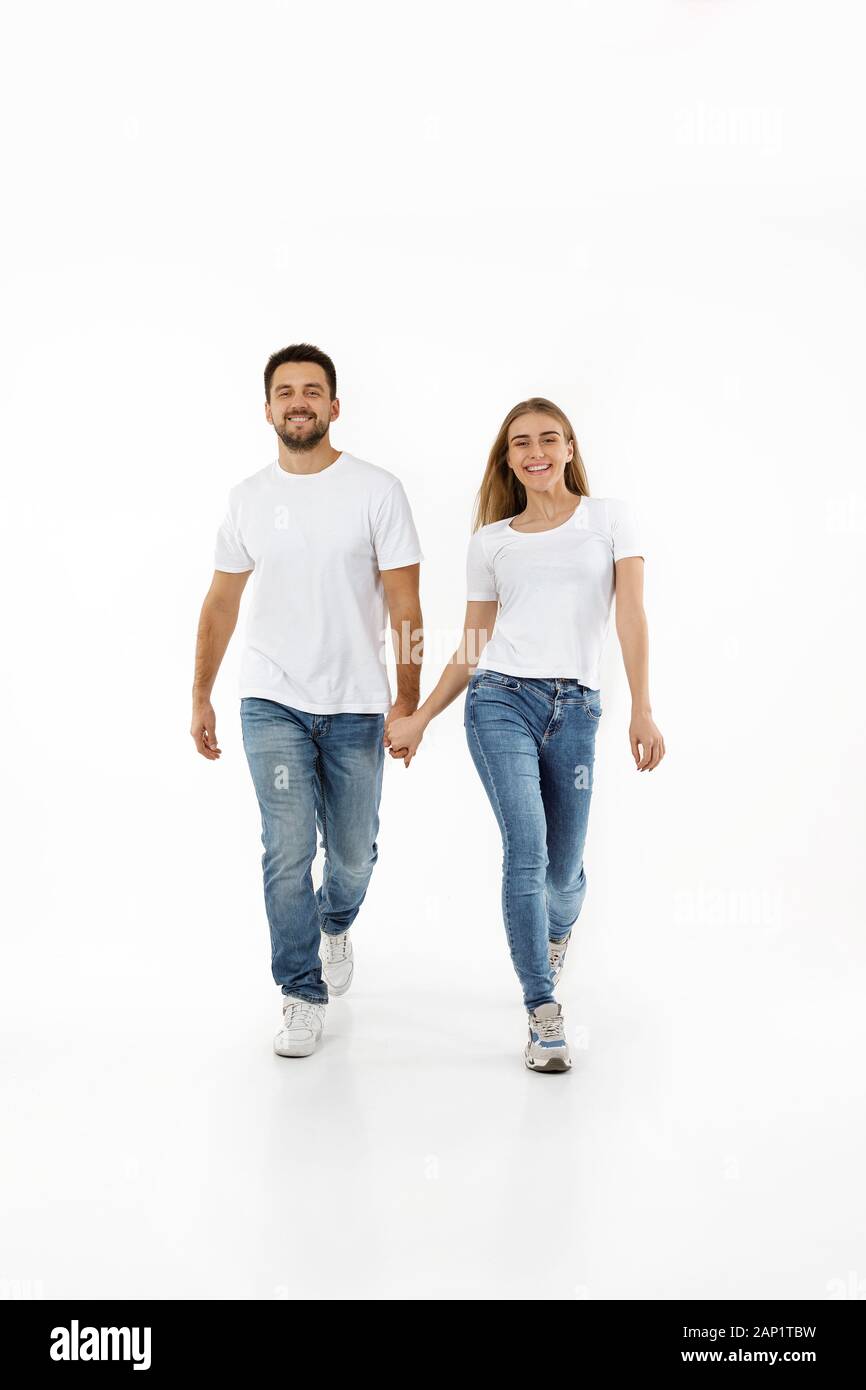 full length portrait of happy couple in casual outfit walking forward ...