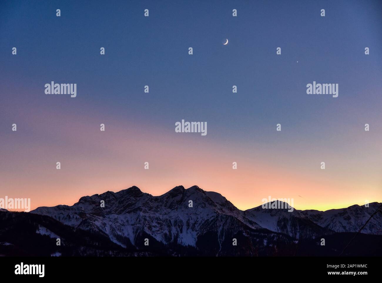 Moon and planet Venus in the sunset lights over the mountains Stock ...