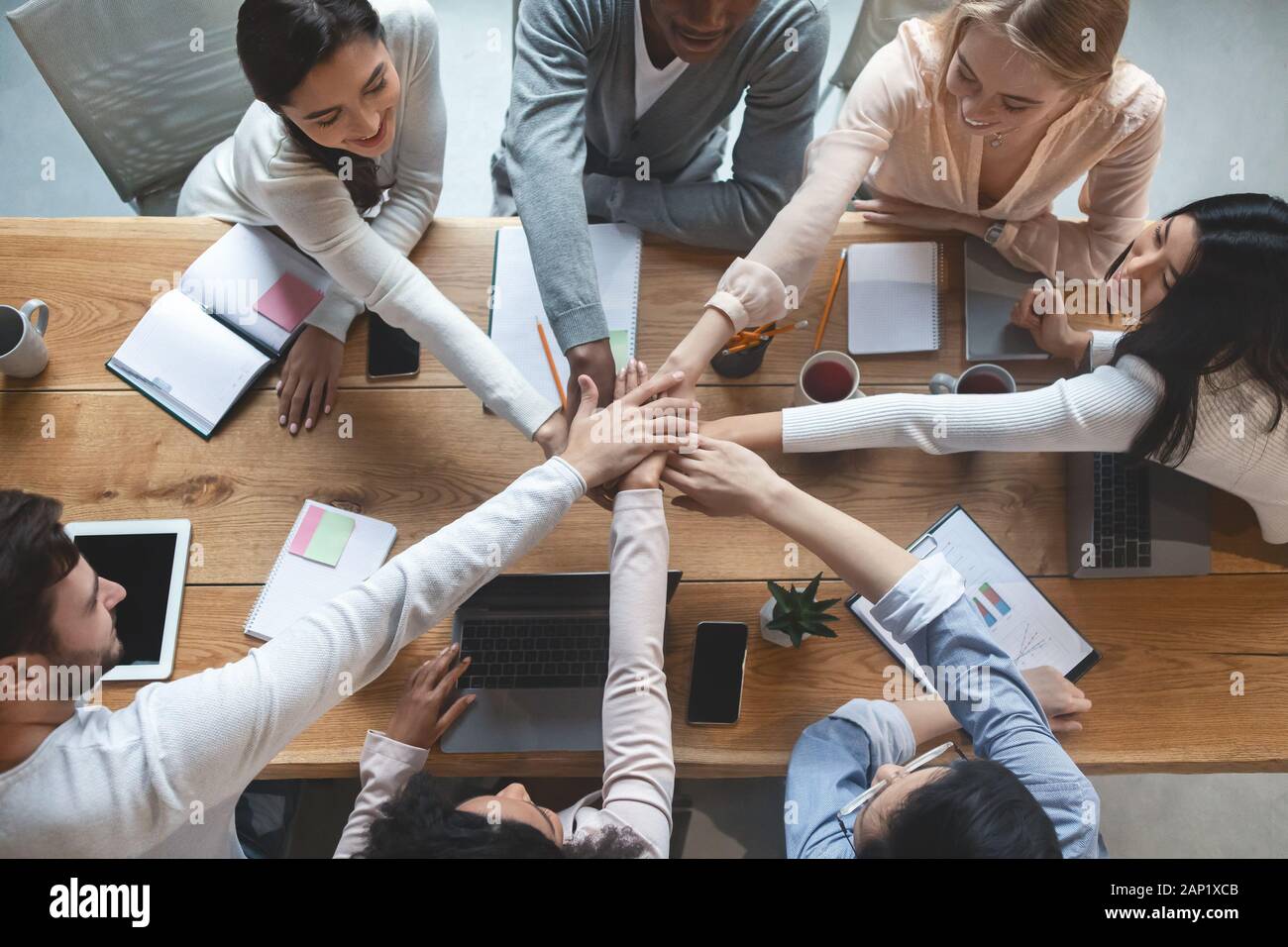 People putting hands together united hi-res stock photography and ...