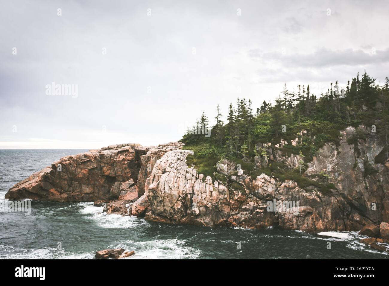 Cinematic landscape of steep, rugged cliffs over rough sea. Cape Breton ...