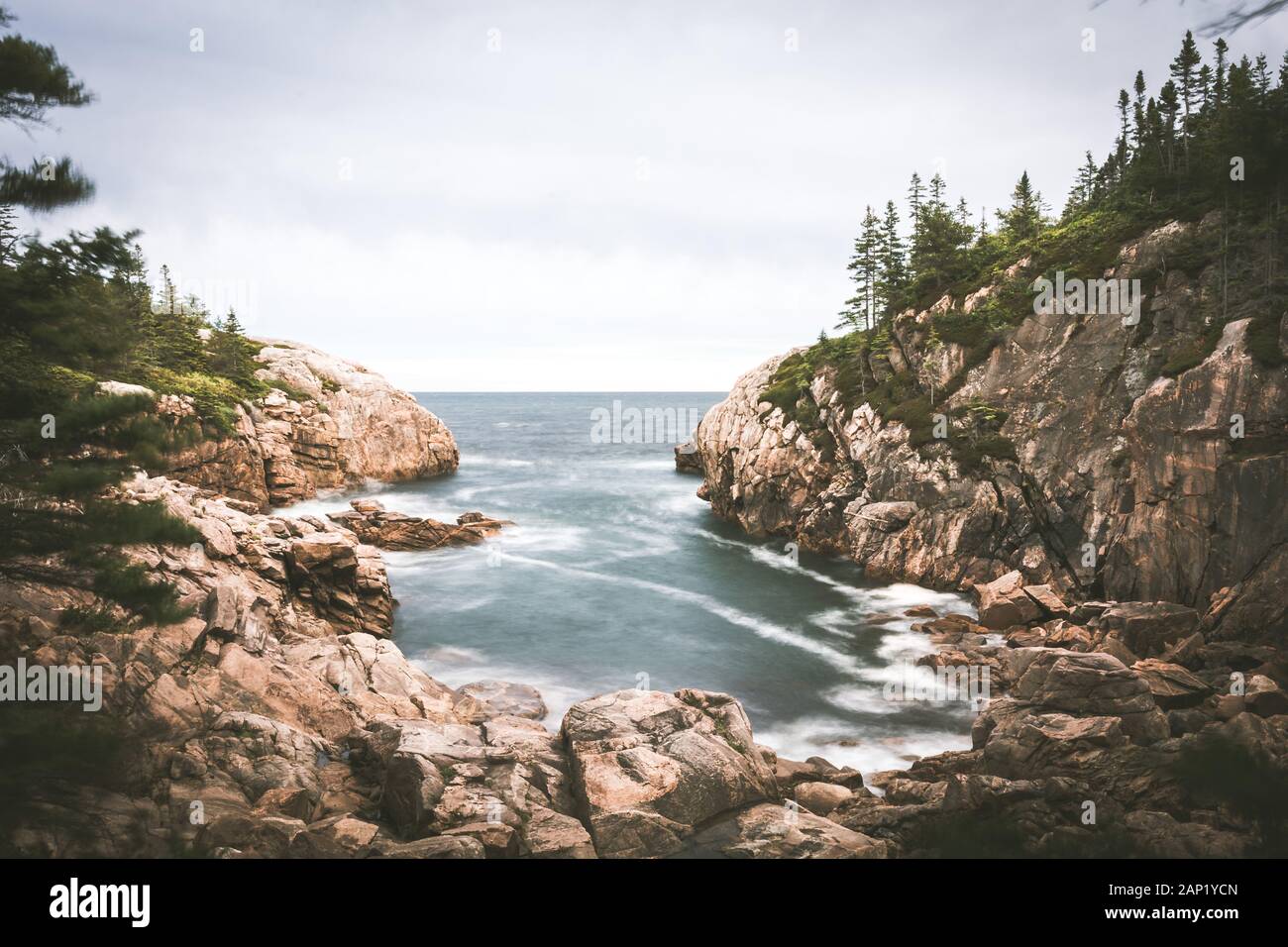 Cinematic landscape of steep, rugged cliffs over rough sea. Cape Breton ...