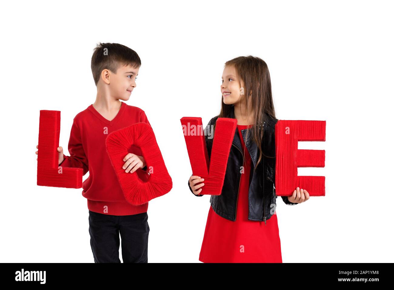 Happy little couple child girl and boy holding red word LOVE isolated ...