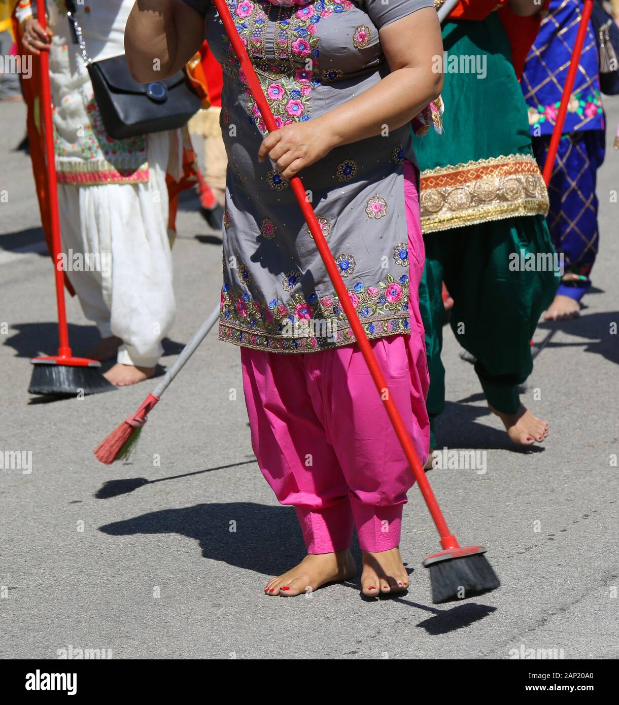 barefoot women of Sikh religious sweep the road with brooms Stock Photo ...