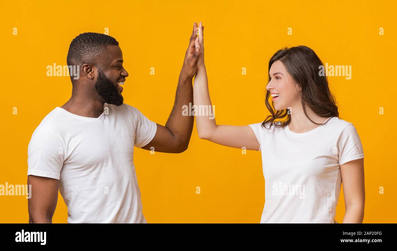 Happy Interracial Couple Giving Each Other High Five, Clapping Palms ...