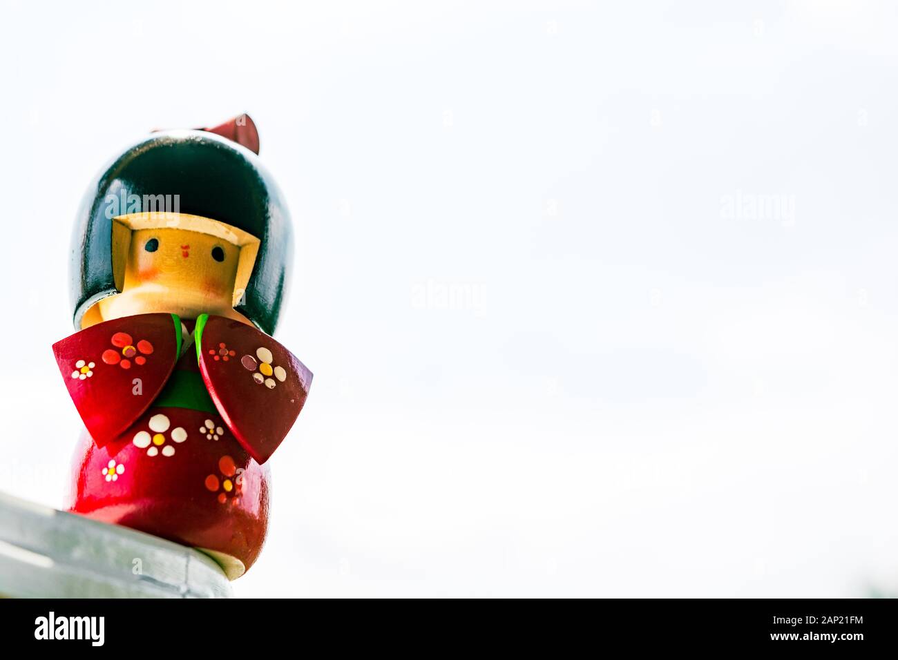 Wooden Japanese Kokeshi Doll Dressed In Traditional Kimono Over White