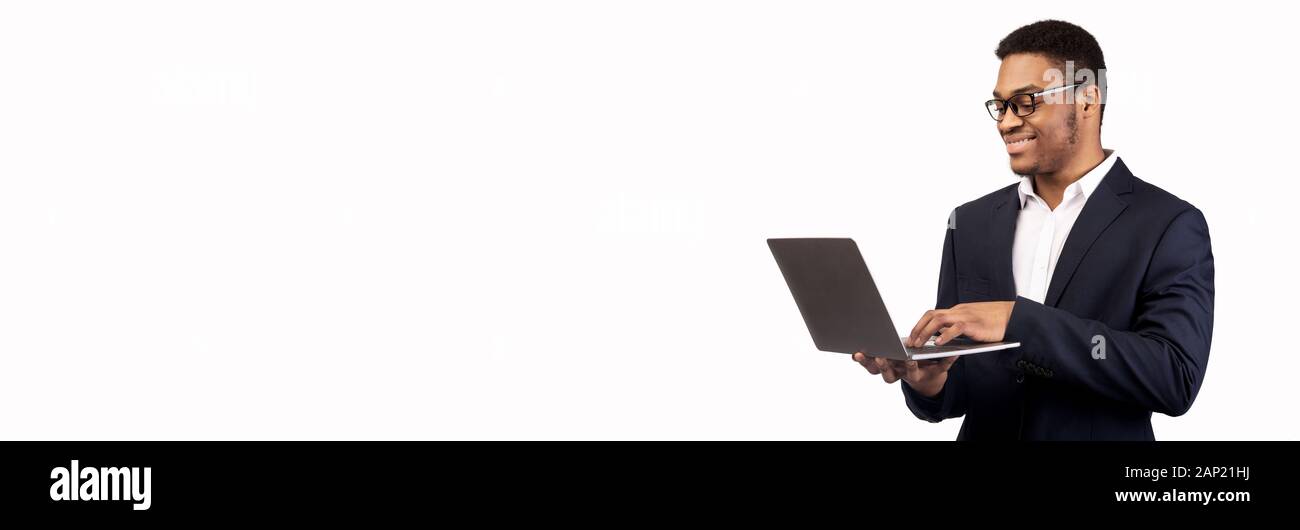 Smiling african american guy using personal computer Stock Photo - Alamy