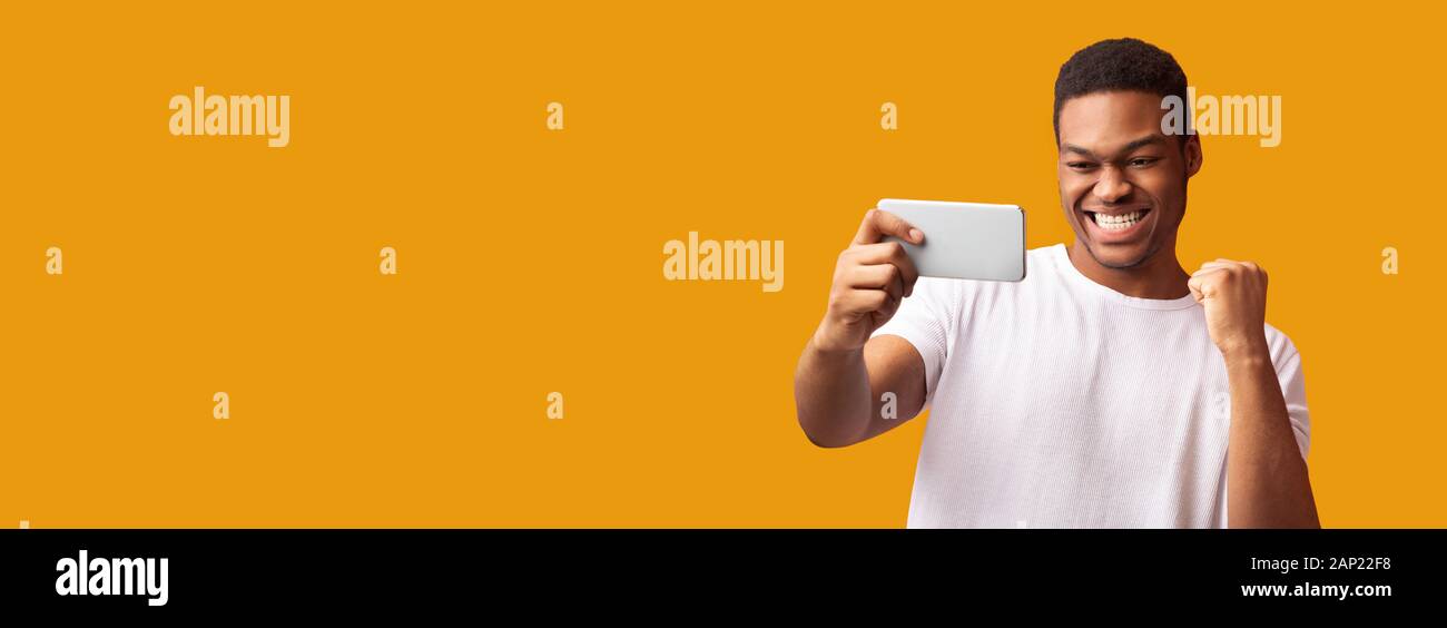 African man celebrating success using hi-res stock photography and ...