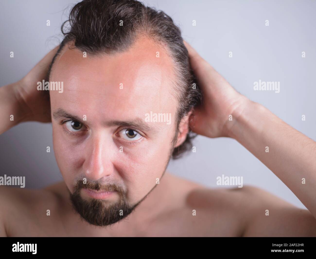 Portrait of a young guy with magnificent hair that falls early on his ...