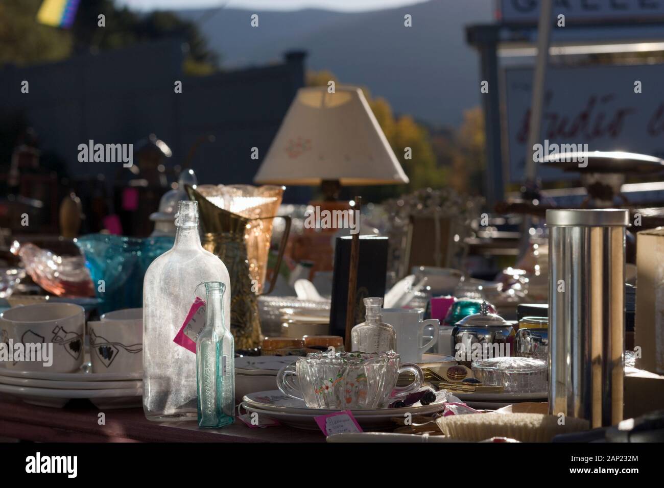 Antique glassware and other household goods for sale at a local flea ...