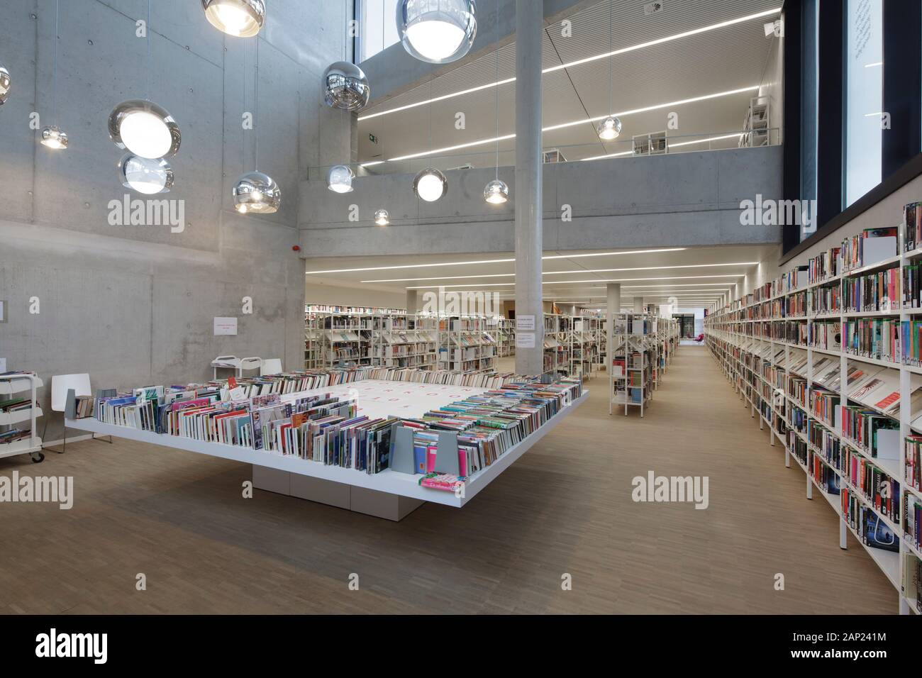 View of library with central table and bookshelves. Cultuurcentrum De ...