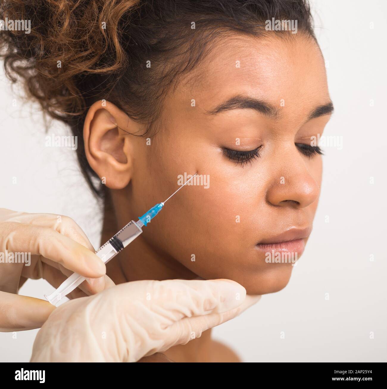 African-american woman making plastic surgery procedure, crop Stock ...