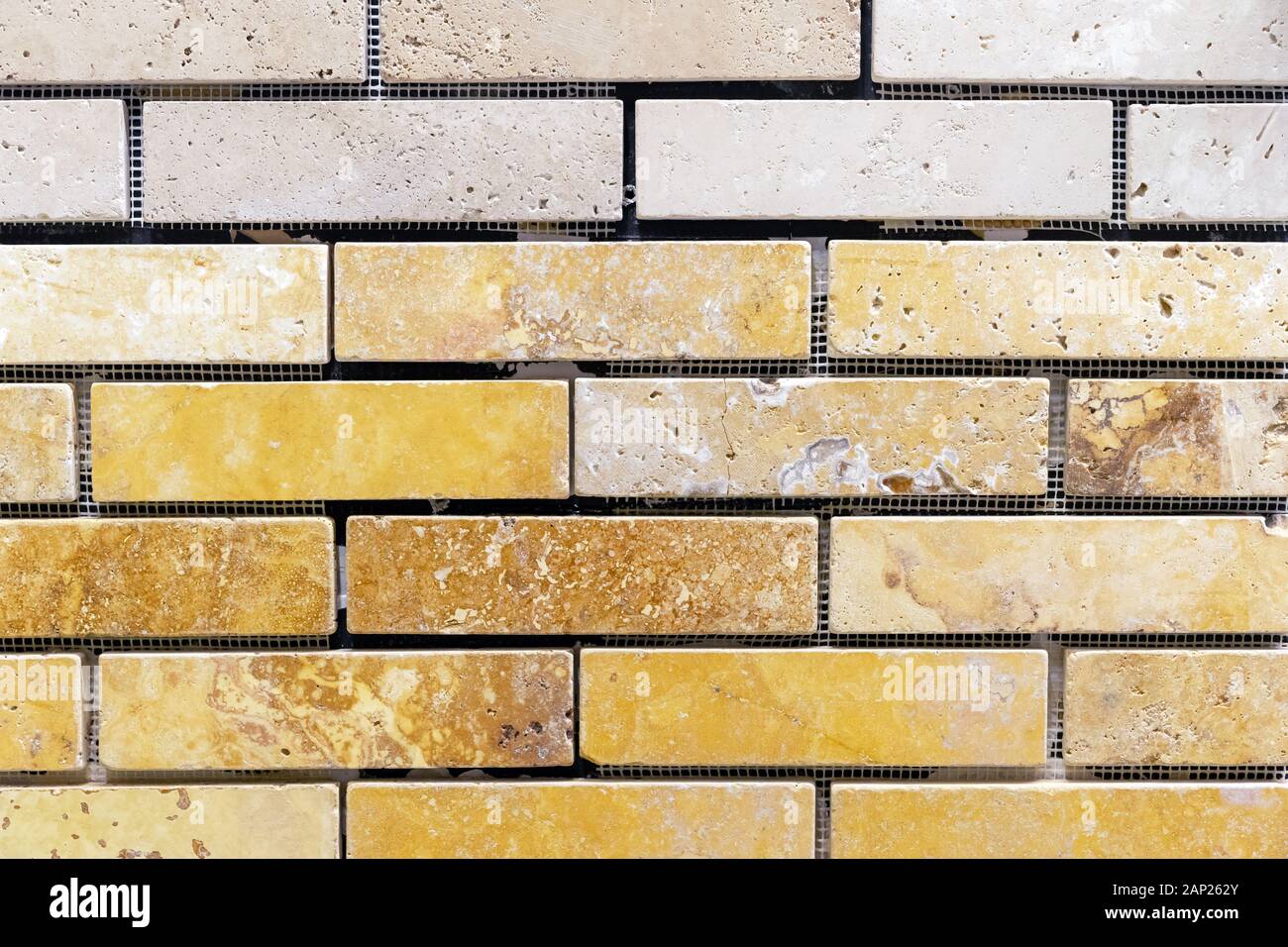 Wall of yellow and beige stone blocks. Background and texture of ...