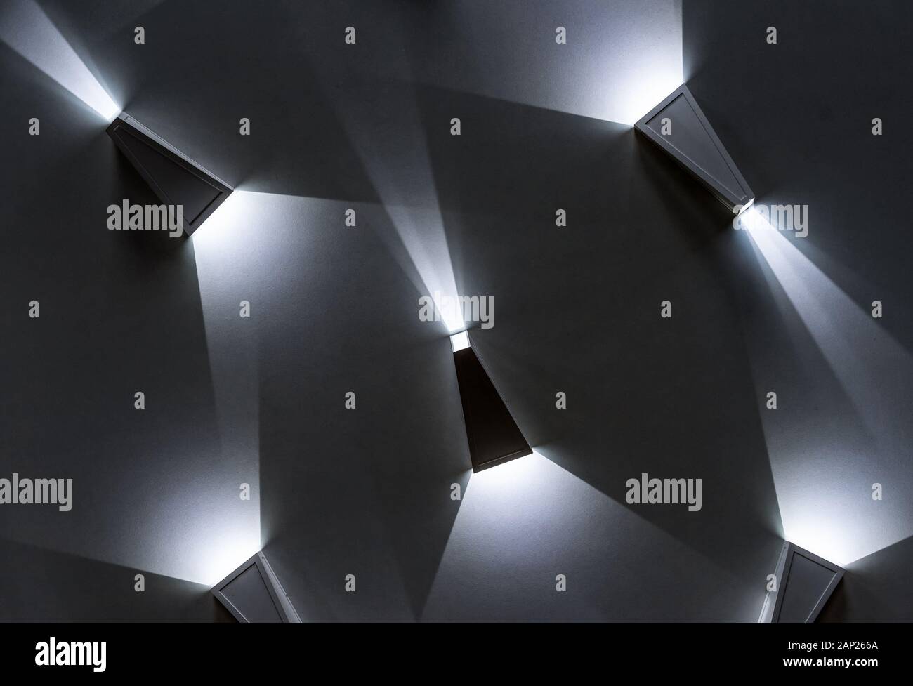 Triangular LED lamps with a white glow. LED lighting in the interior ...