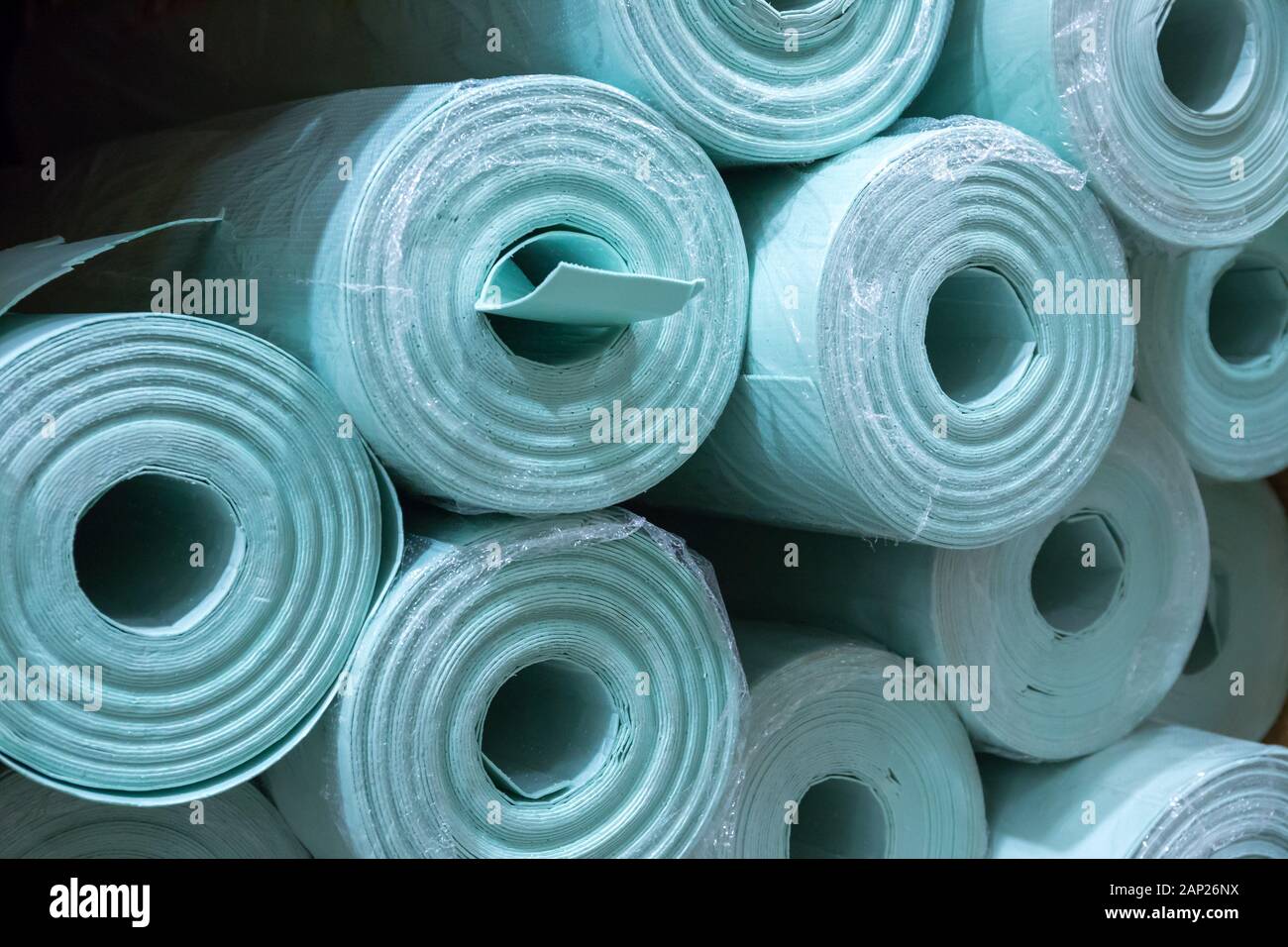 Pile of insulation material rolls. Light green or blue color. Filled ...
