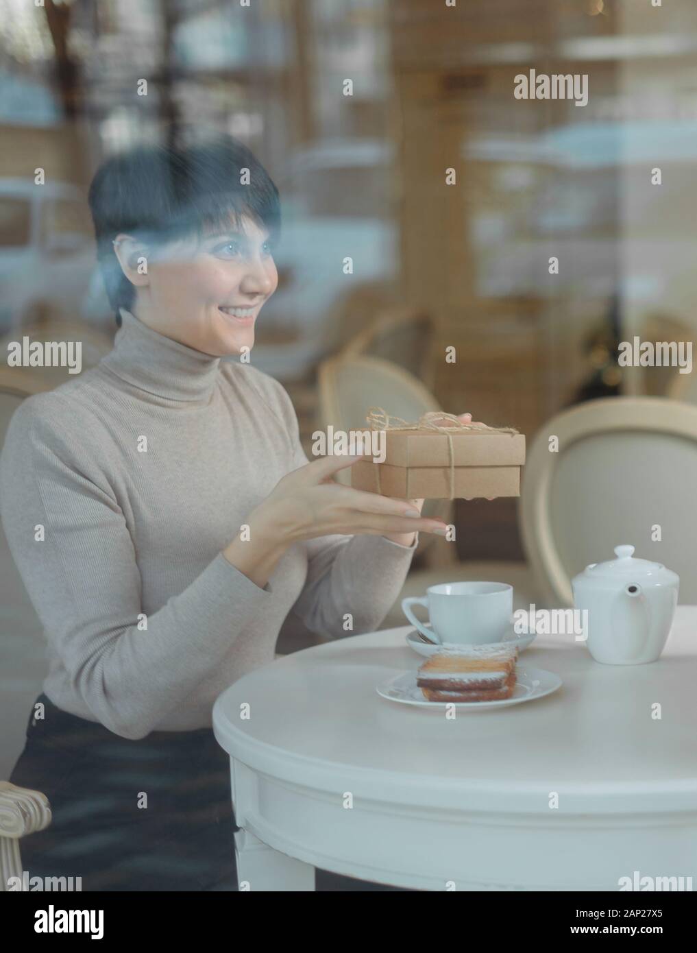 Pleasant woman making a present Stock Photo - Alamy