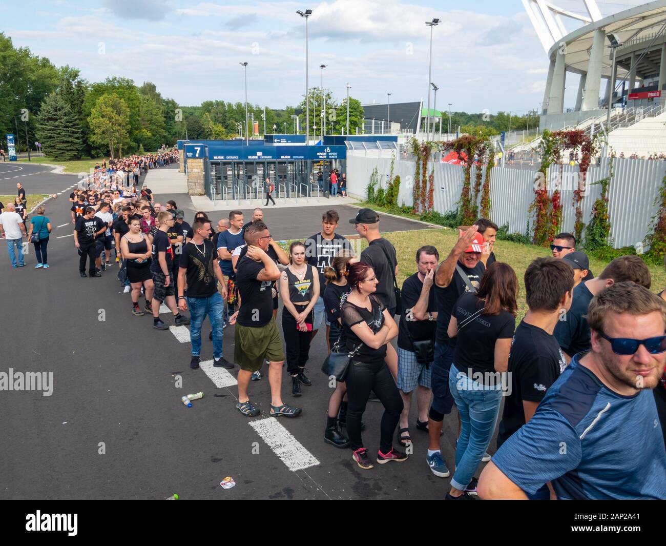 Visitors are waiting in line before the concert to enter the stadium ...