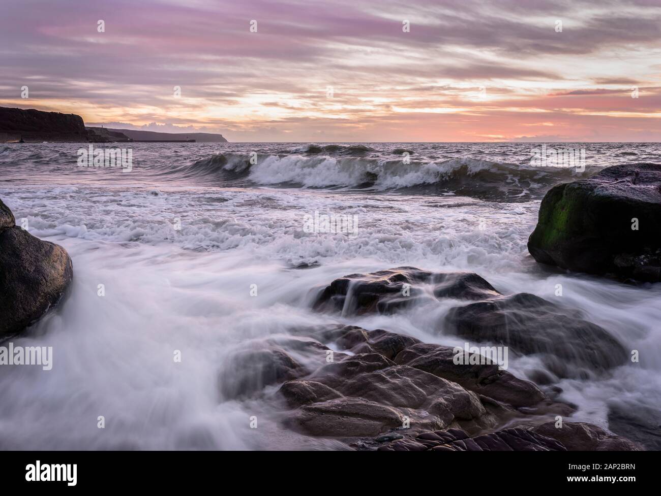 Winter sunset and waves off the Cumbrian coast - UK Stock Photo - Alamy