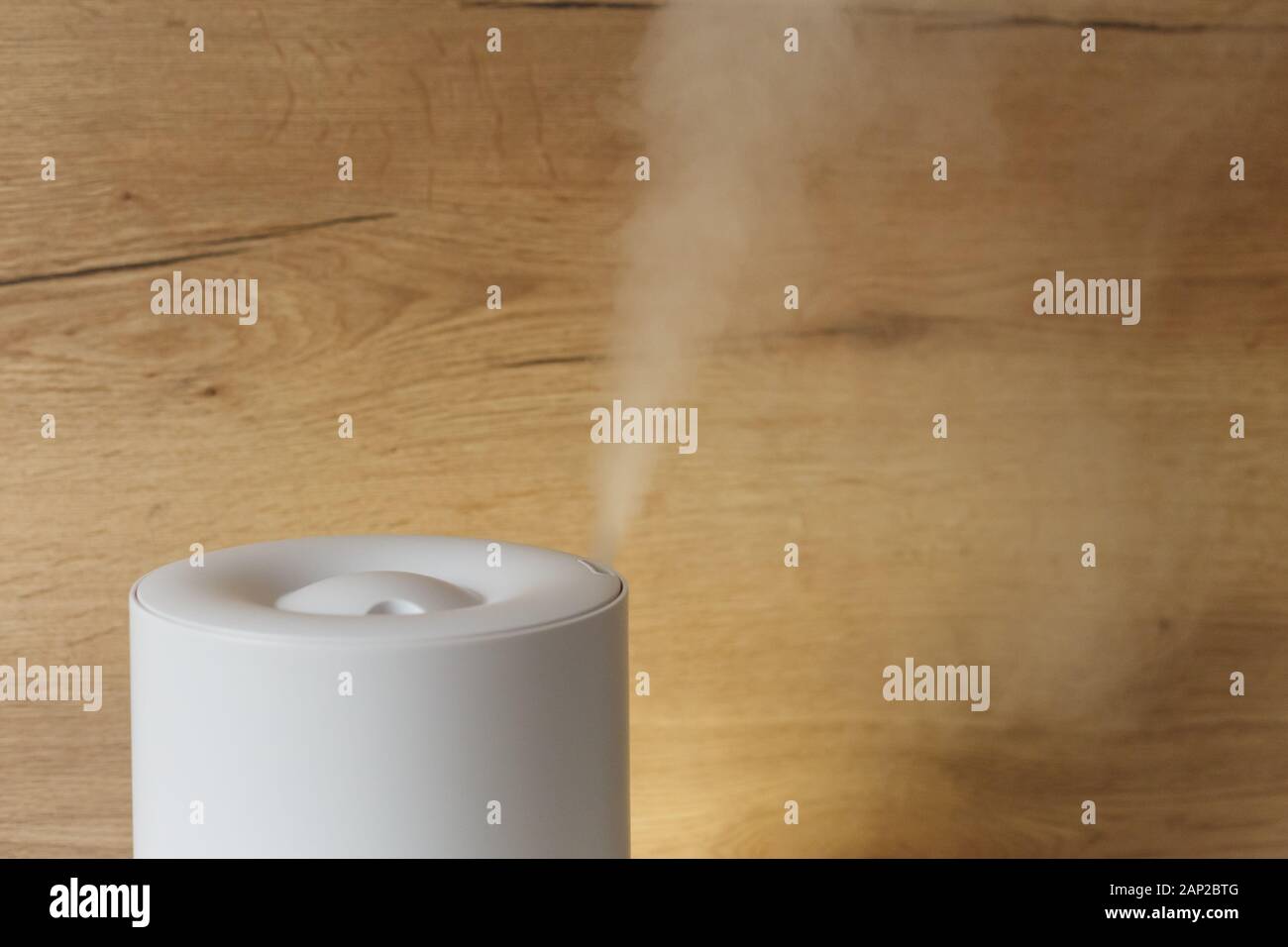 Humidifier spreading steam into the living room Stock Photo - Alamy