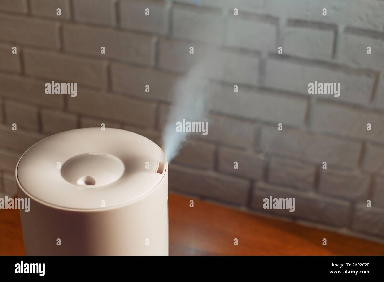 Humidifier spreading steam into the living room Stock Photo - Alamy