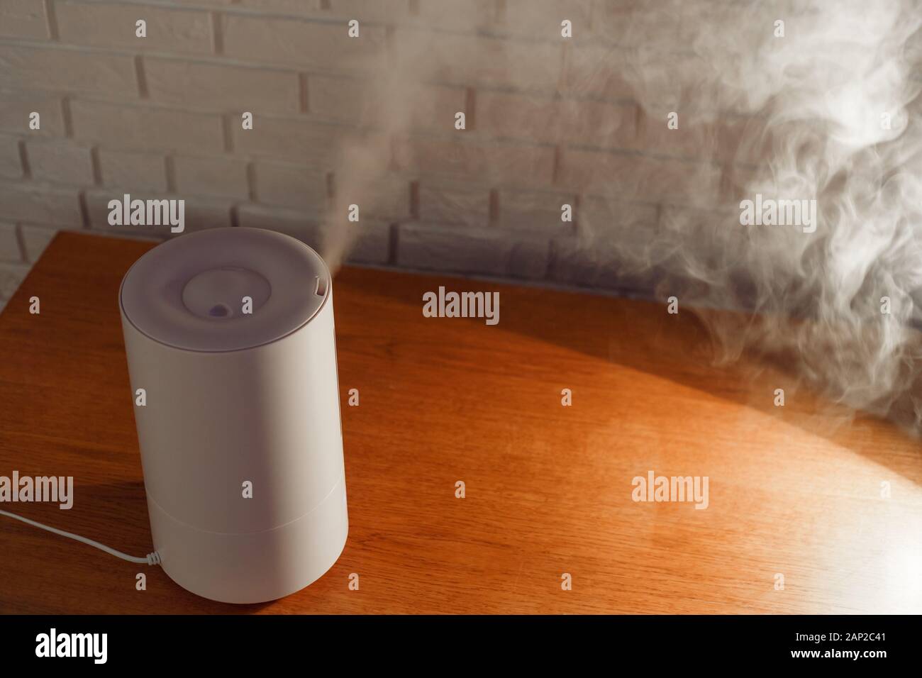 Humidifier spreading steam into the living room Stock Photo - Alamy