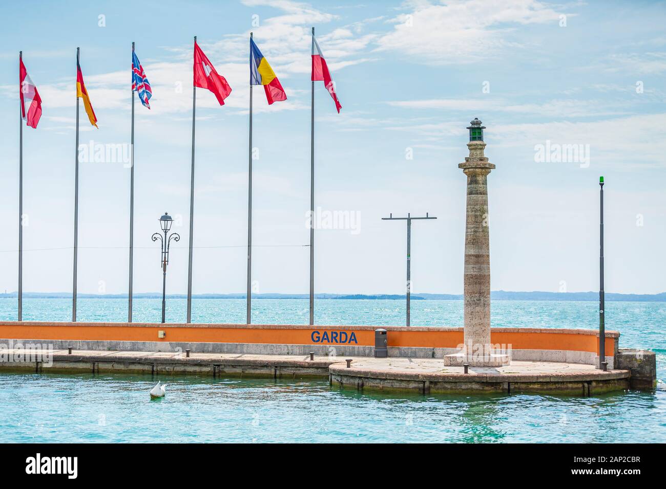 International flags at Garda town harbor. Sunny summer day Stock Photo ...