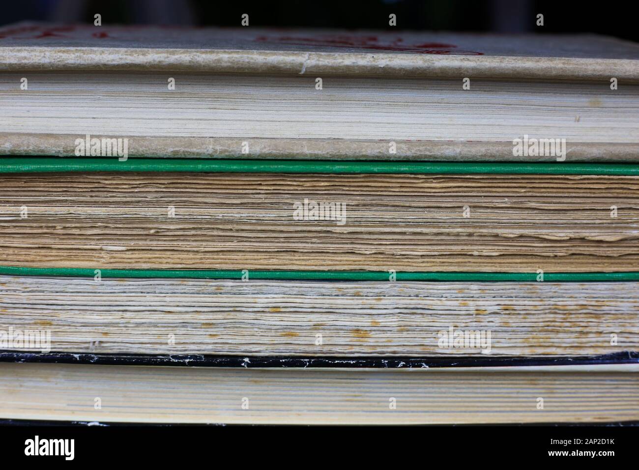 View on isolated pile of antique yellowed books with edges of cover and ...