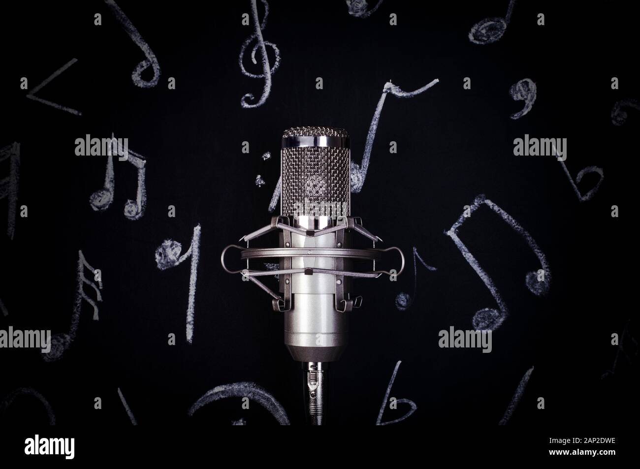 microphone on the background of the board for chalk with painted notes ...