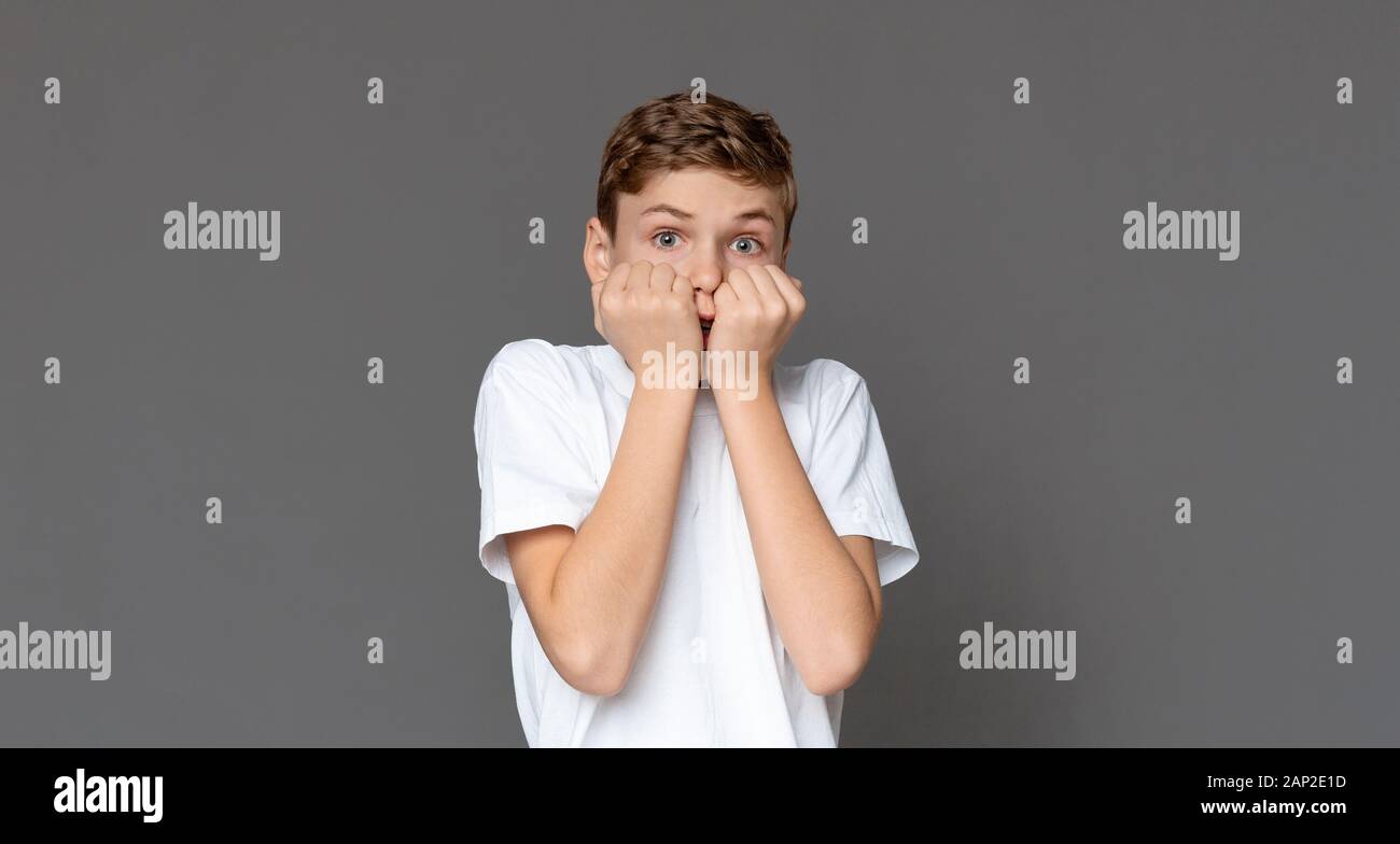 Scared teen boy looking at camera with amazement Stock Photo - Alamy