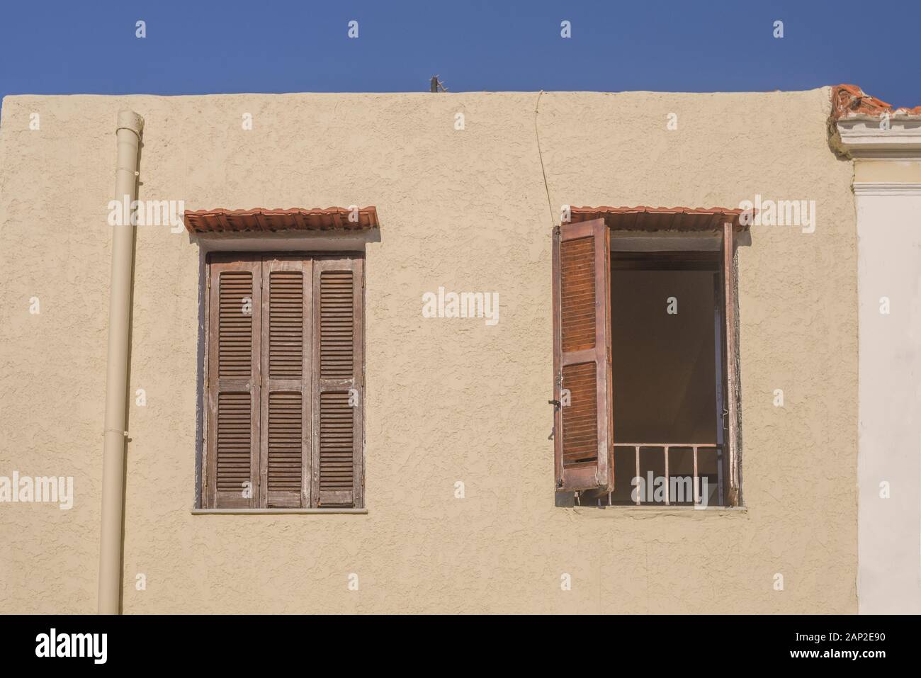 Two windows in an yellow building. Rhodes, Greece Stock Photo - Alamy