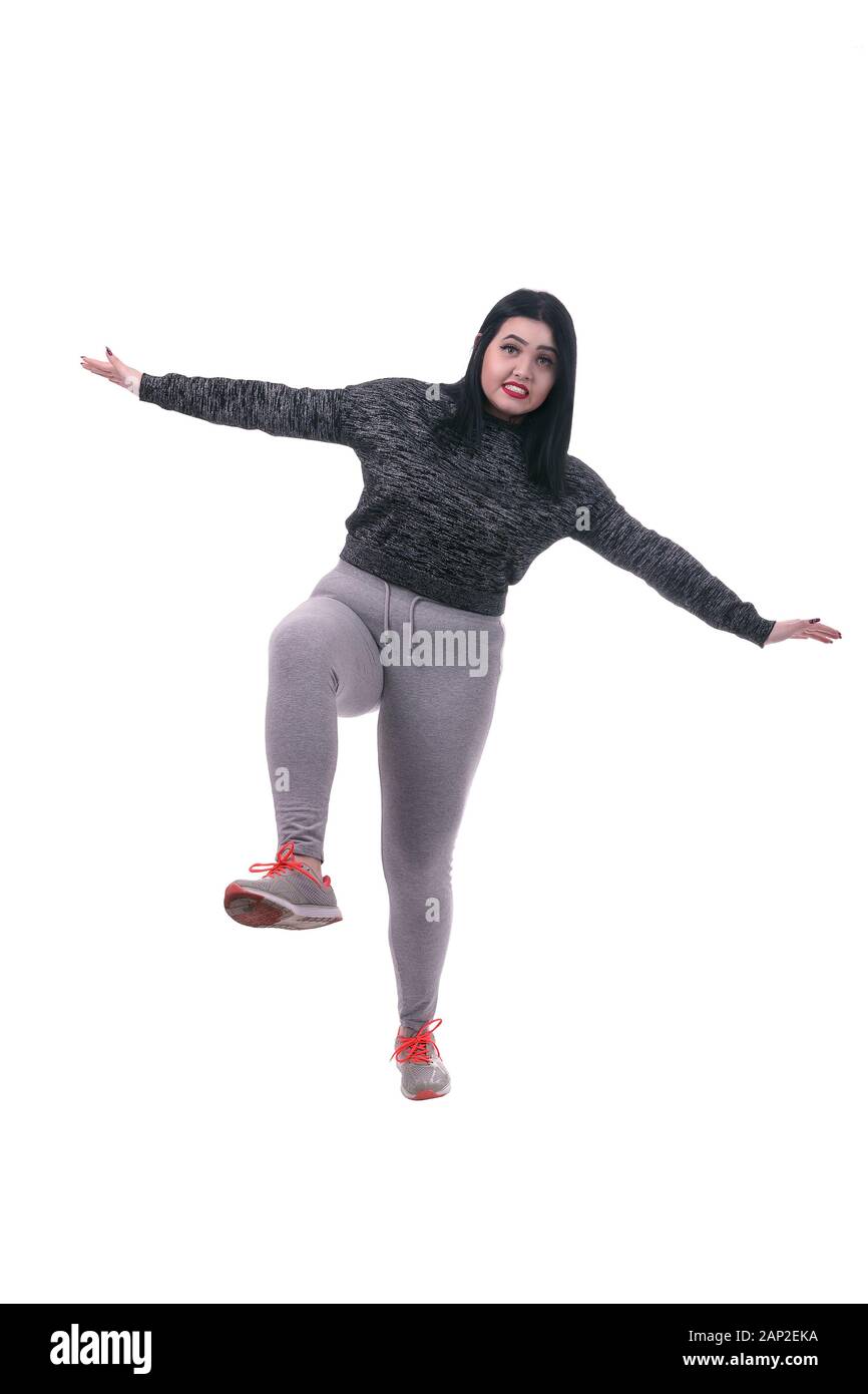 plus size model in sporty form standing on one leg, isolated on white ...