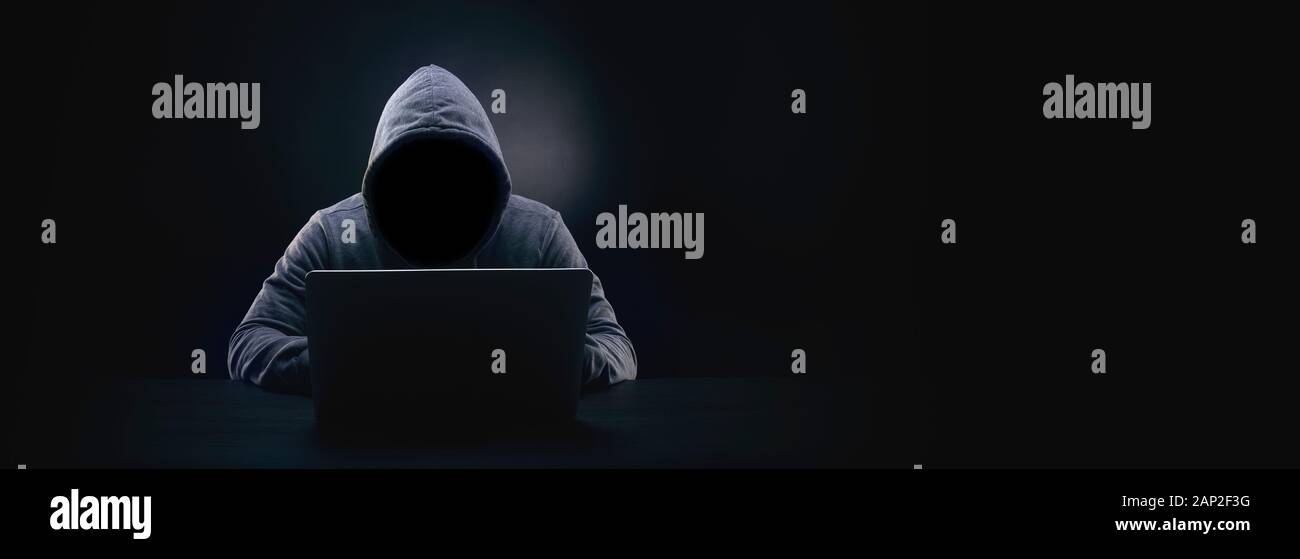 hacker without face in a hood on a dark background, panoramic mock-up with space for text Stock ...