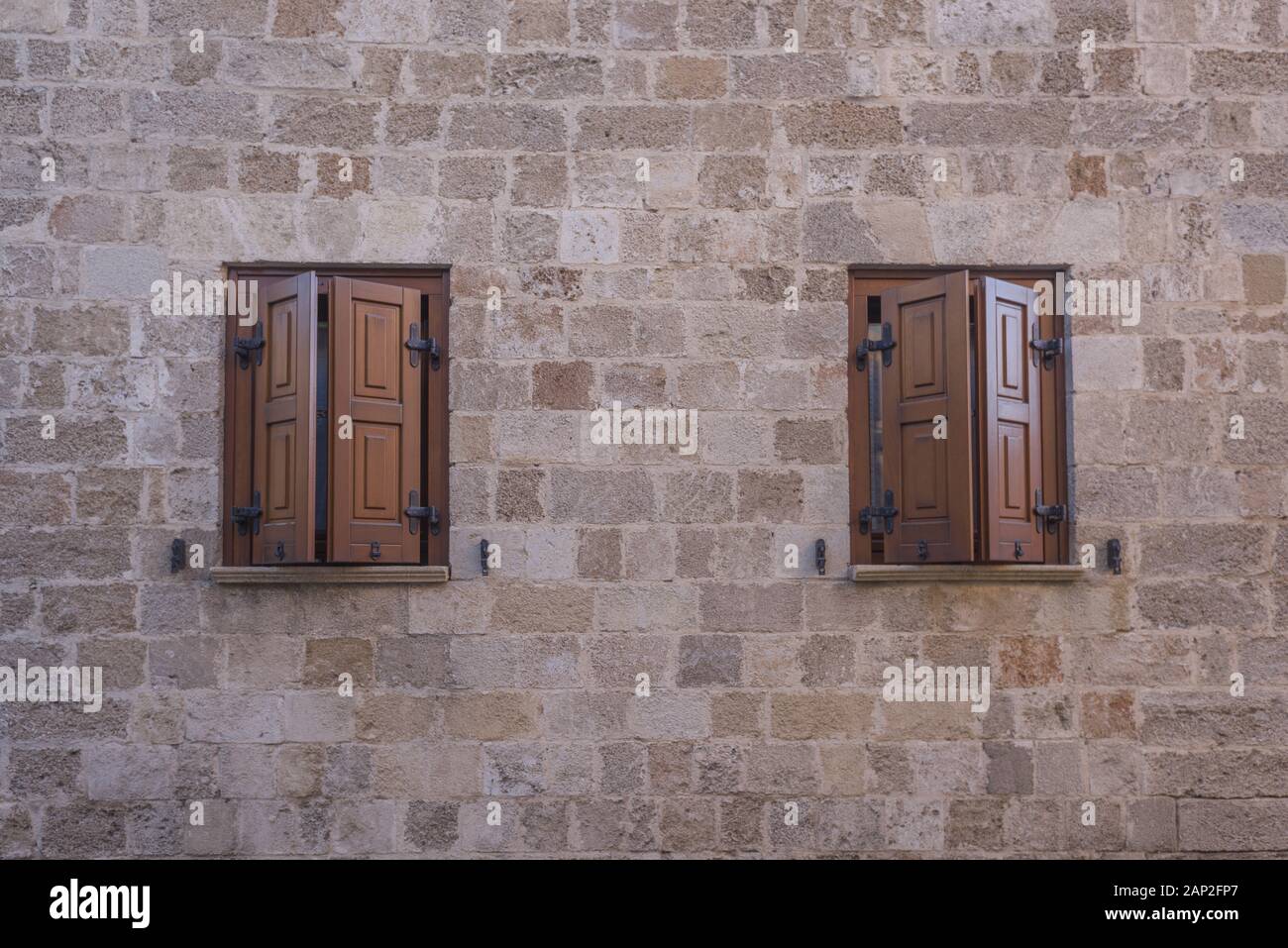 two windows in an old building. Cityscape of medieval city inside of ...