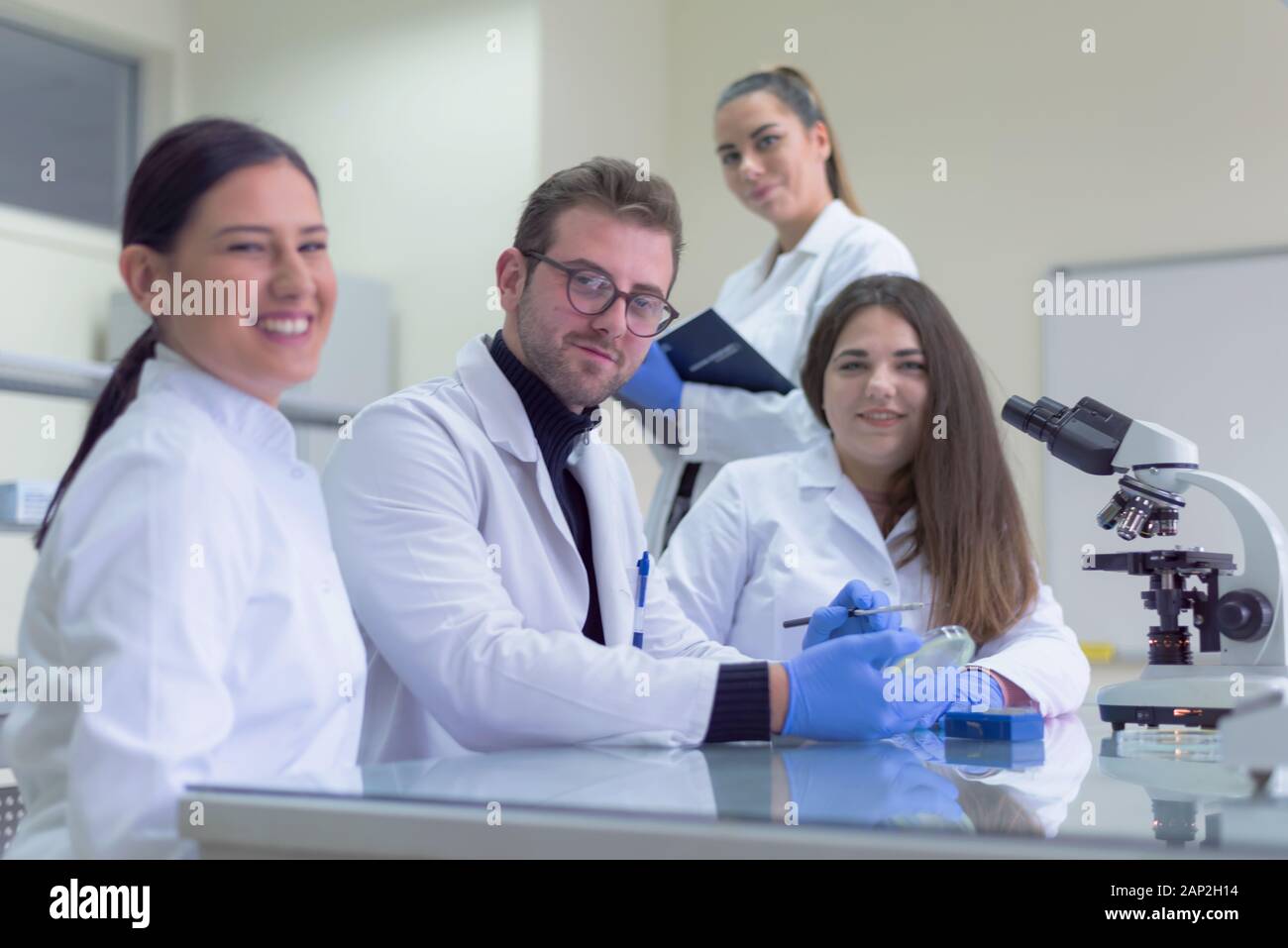 Group of Laboratory scientists working at lab with test tubes, test or ...