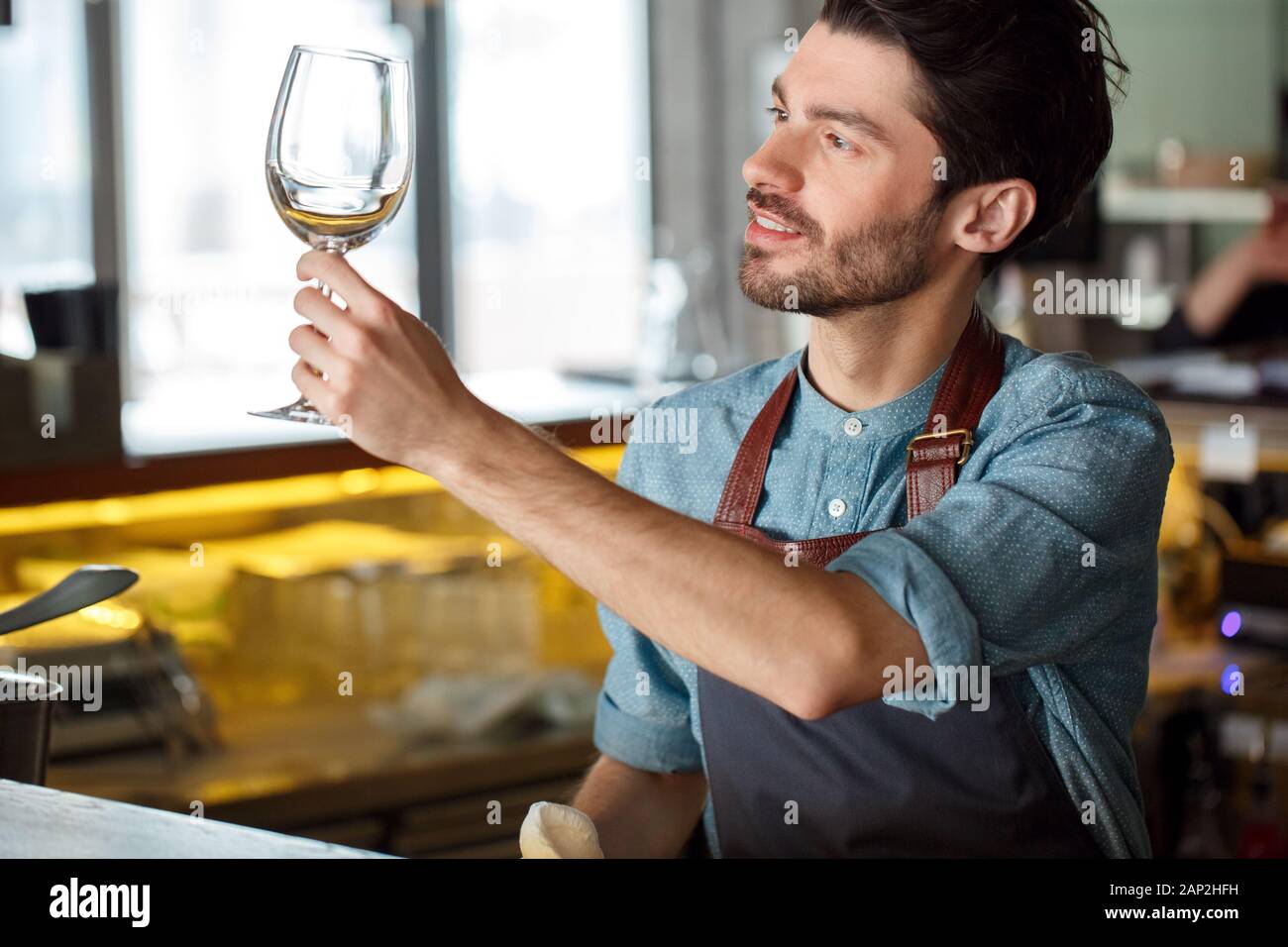 Professional Occupation. Bartender standing at counter checking ...