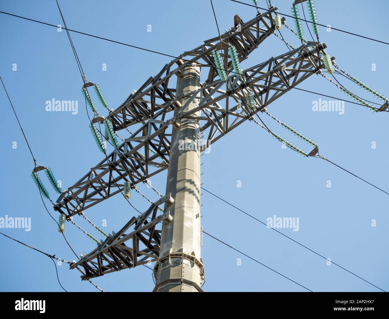 Large electric pole with wires on a blue sky background Stock Photo - Alamy