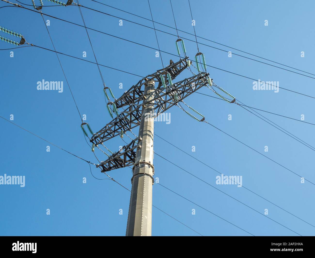 Large electric pole with wires on a blue sky background Stock Photo - Alamy
