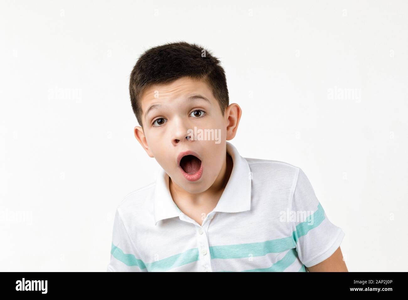 surprised little child boy in t-shirt looking to camera on white ...