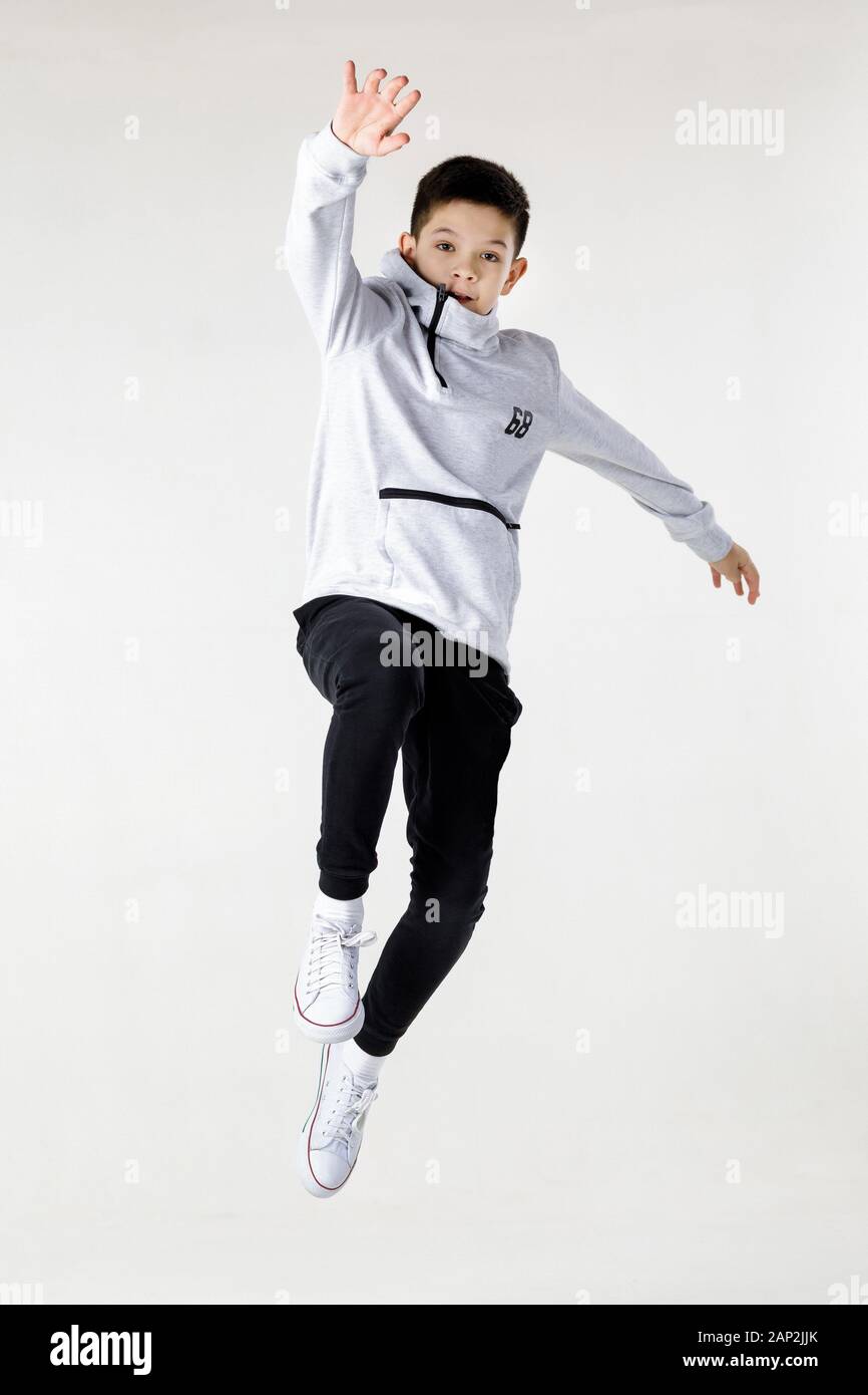 emotional little boy jumping on white studio background Stock Photo - Alamy