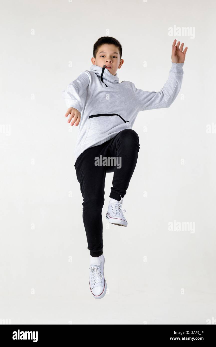 emotional little boy jumping on white studio background Stock Photo - Alamy
