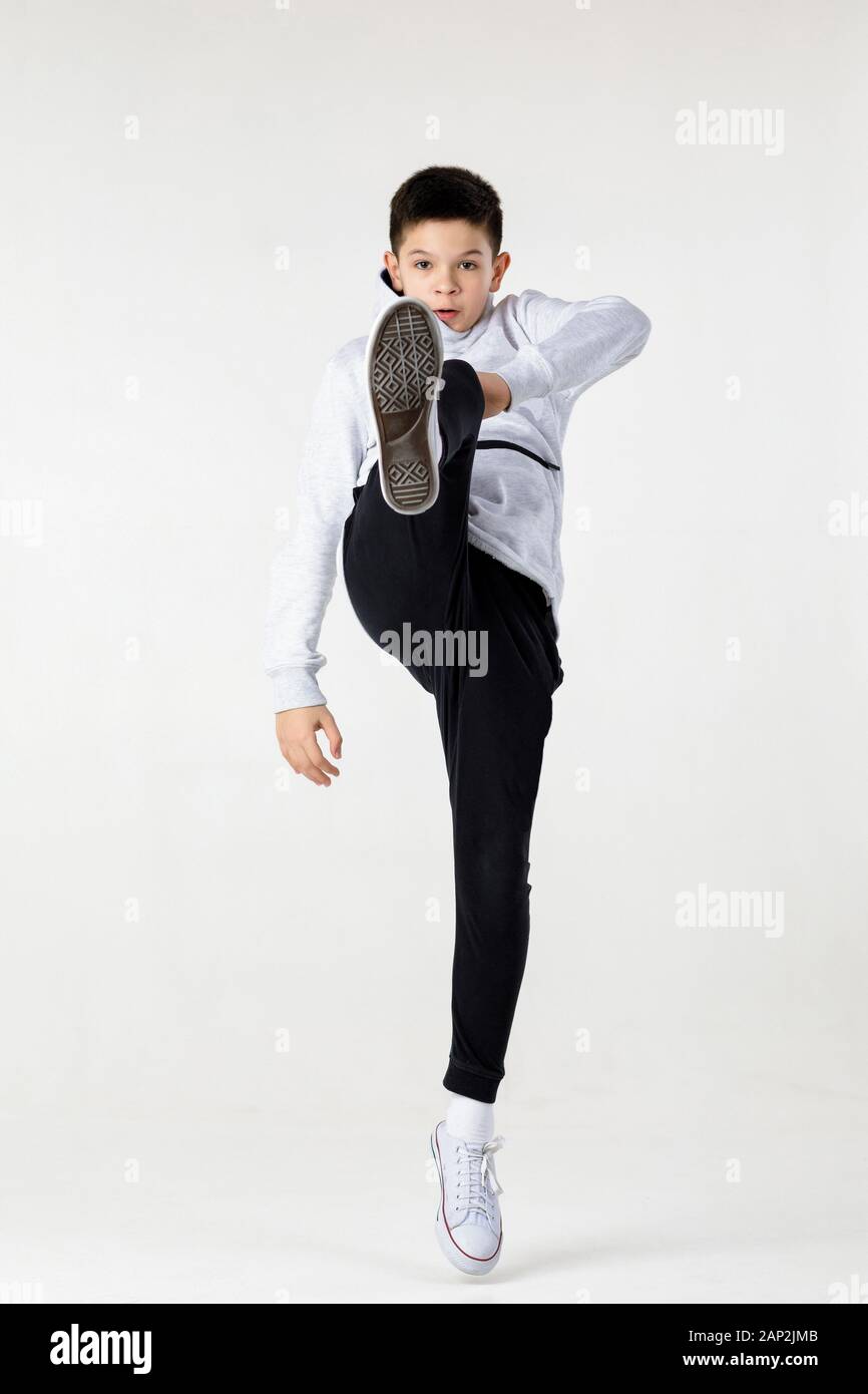 Little hip-hop boy dancing on white studio background Stock Photo - Alamy