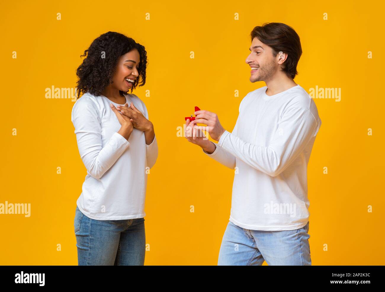 Romantic guy proposing to his surprised girlfriend, giving ring Stock ...