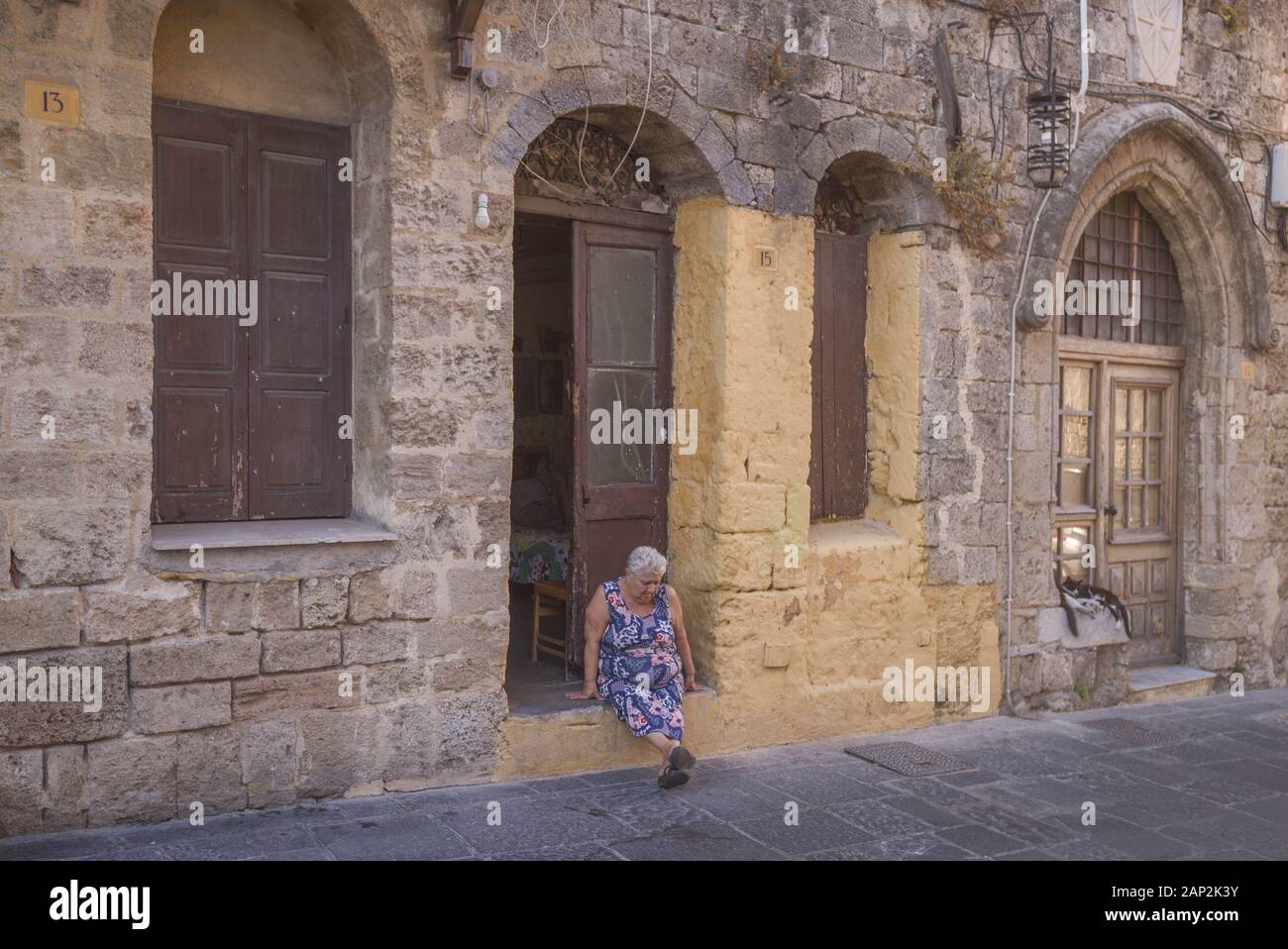 August 8, 2018, Rhodes, Greece: An elderly woman sits on the steps of ...