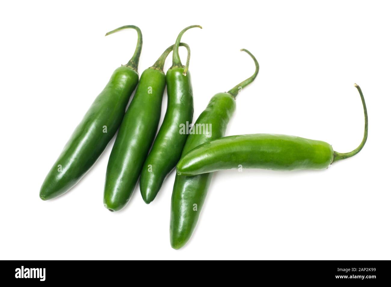 Five Serrano chili Peppers isolated on white background Stock Photo - Alamy