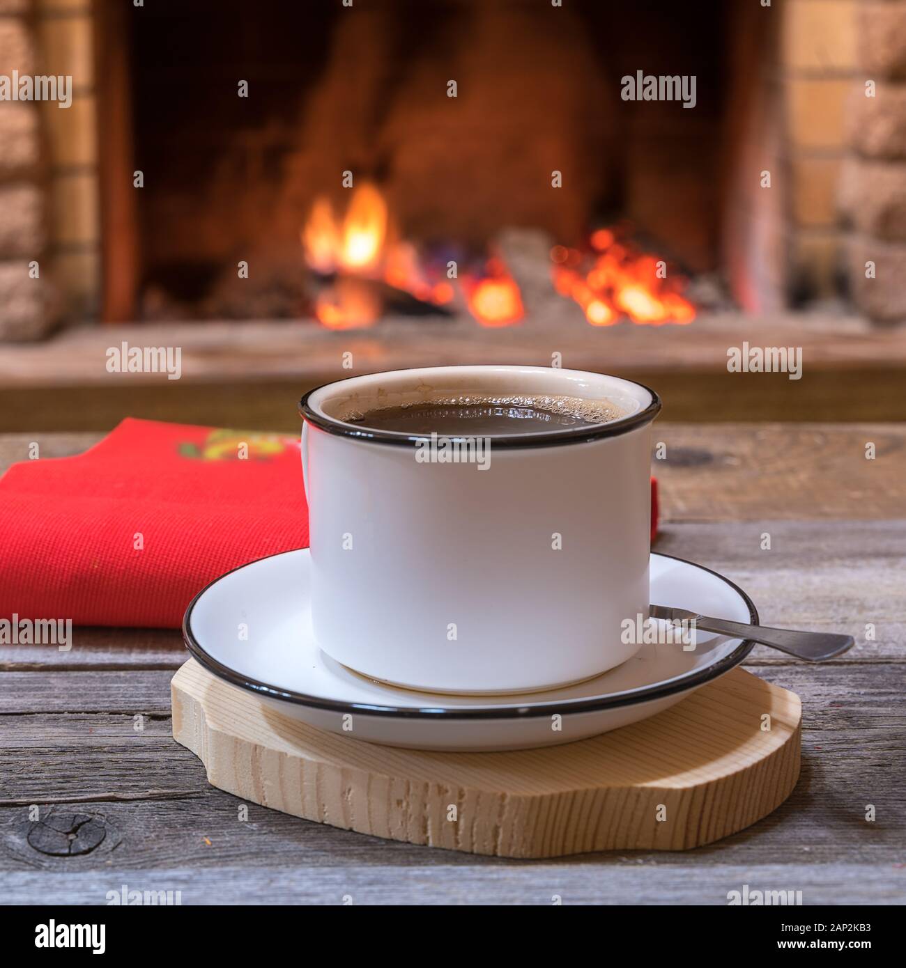 Cozy scene before fireplace with a cup of tea, in country house, winter ...