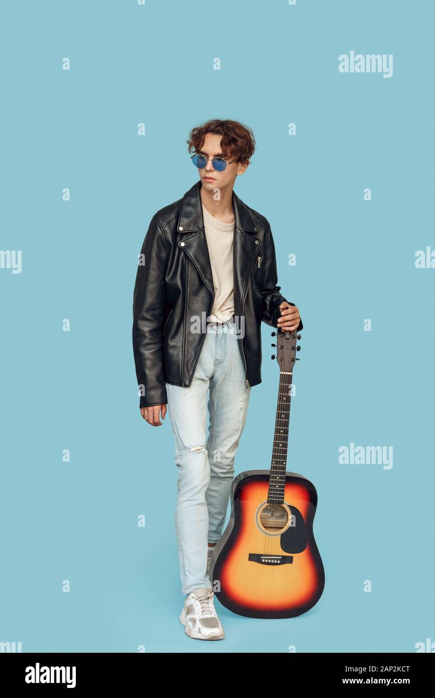 Freestyle. Man in leather jacket and sunglasses walking isolated on ...