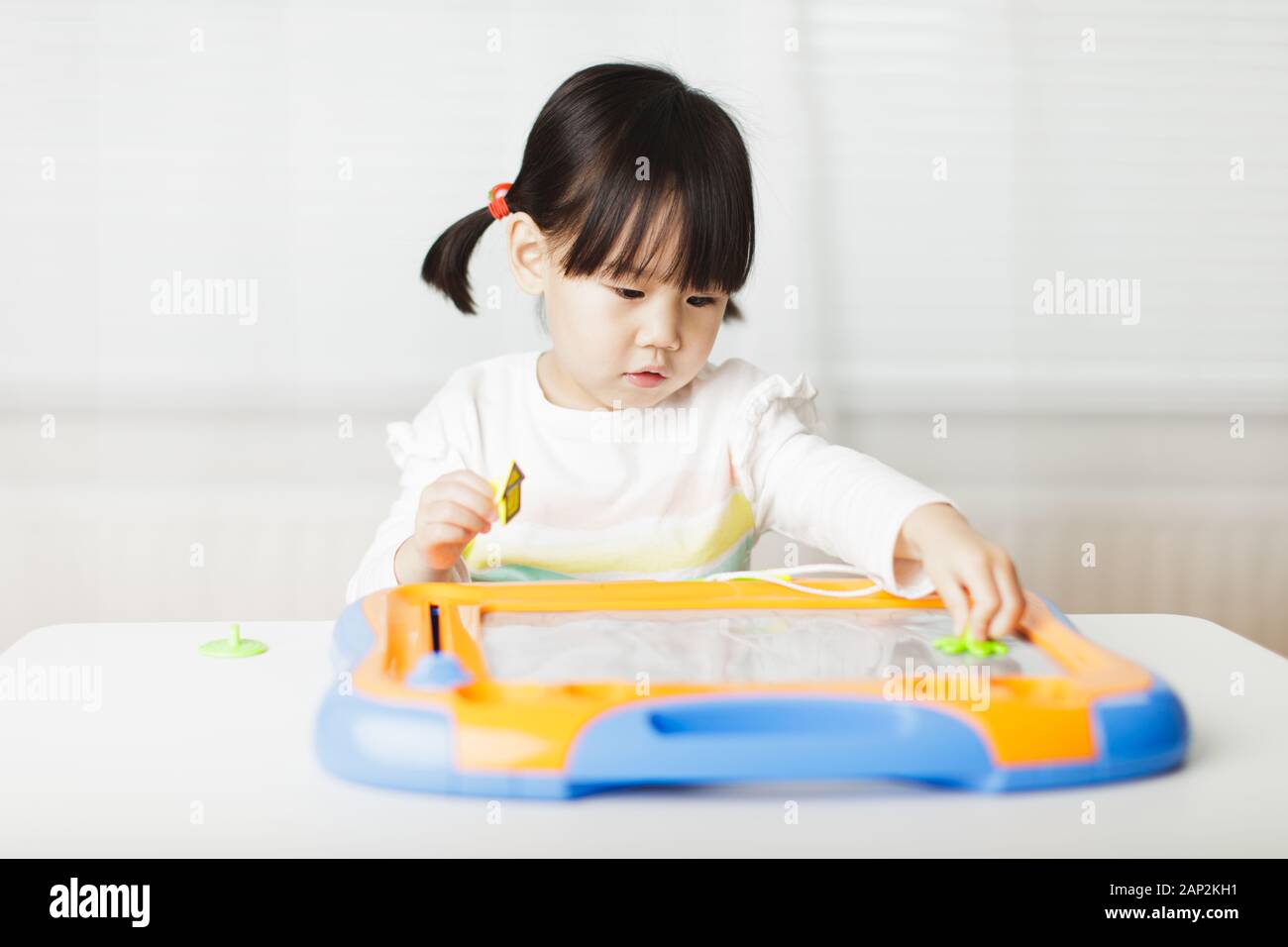 toddler girl learn drawing at home against white background Stock Photo ...