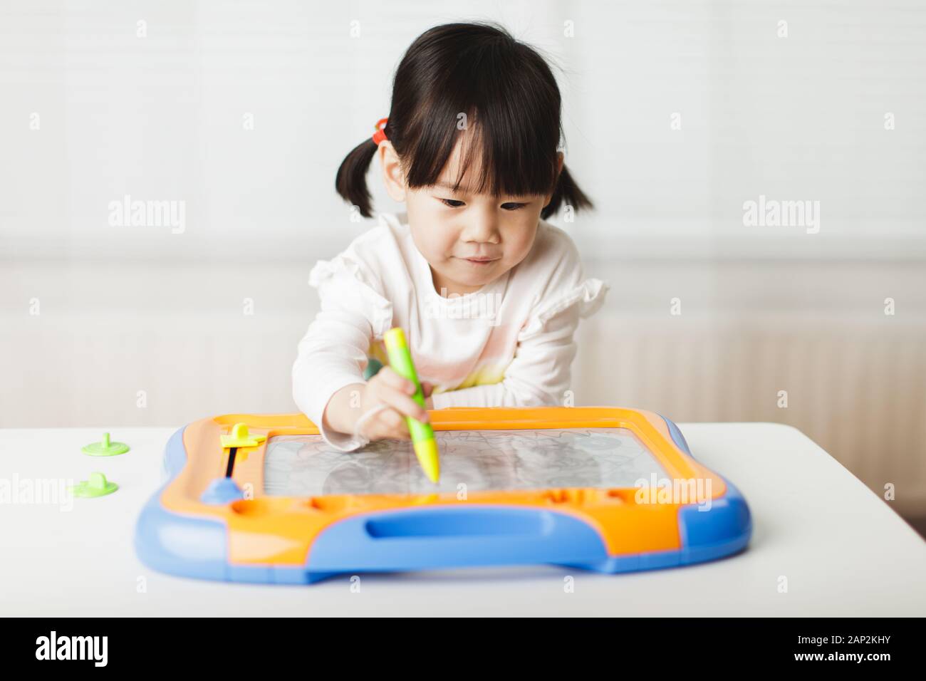 toddler girl learn drawing at home against white background Stock Photo ...
